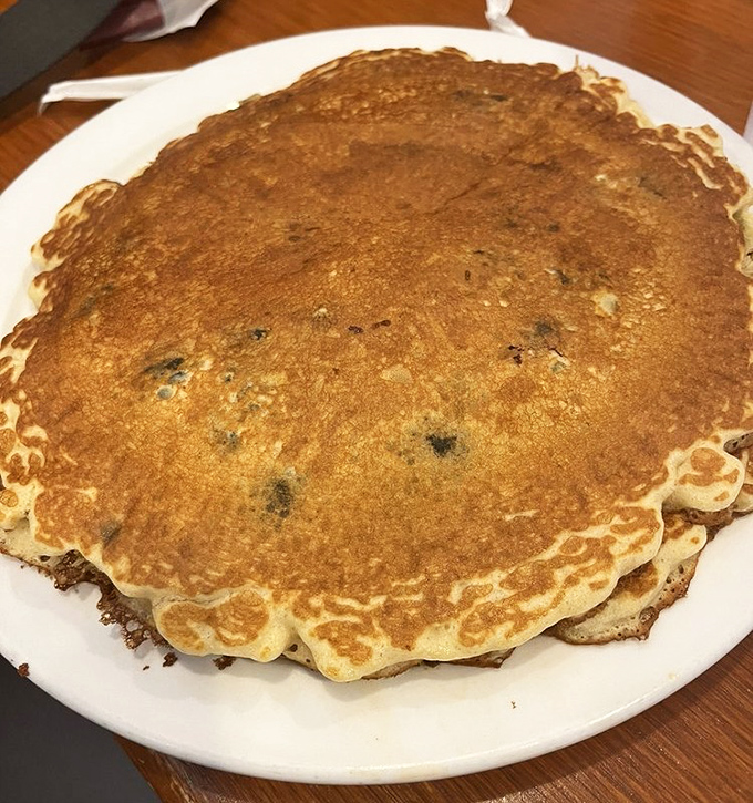 That blueberry pancake spans the entire plate like breakfast's answer to a vinyl record, studded with fruity flavor throughout.
