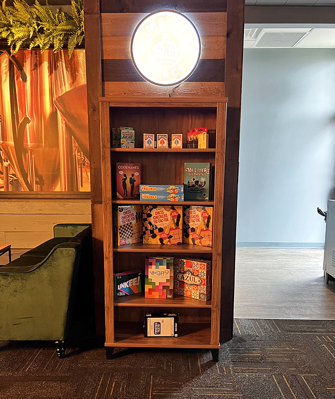 Board games stacked neatly on wooden shelves &ndash; because sometimes the best digestif after a great meal is crushing your friends at Monopoly.