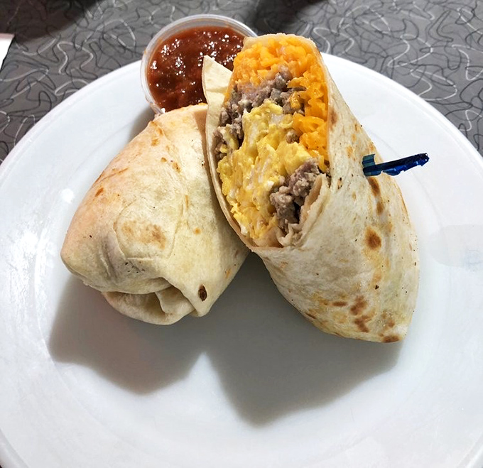 A breakfast burrito cut to reveal its secrets&mdash;like a culinary magic trick where everyone wins, especially your taste buds.