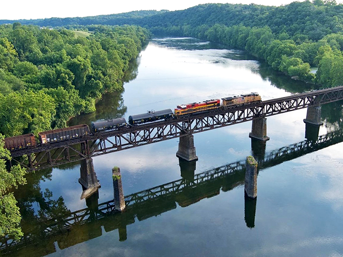 Trains still rumble across bridges here, connecting past to present like a steel time machine over water.
