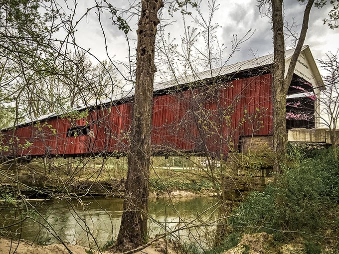 Framed by spring foliage, the bridge's weathered red sides tell stories of countless crossings. If only these timbers could talk.