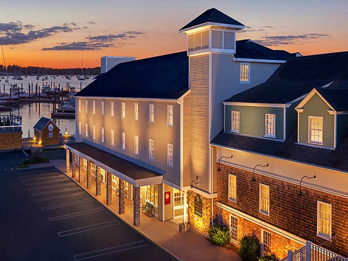 The Bristol Harbor Inn glows at sunset, transforming from charming daytime retreat to magical evening haven overlooking the twinkling marina lights.