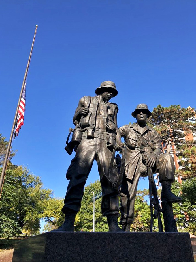 Silent sentinels in bronze honor sacrifice and brotherhood, standing watch over the park with quiet dignity.