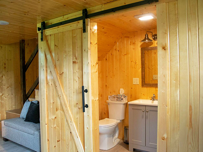 Even the bathroom embraces rustic elegance. The sliding barn door adds character while proving country comfort doesn't mean sacrificing modern necessities.