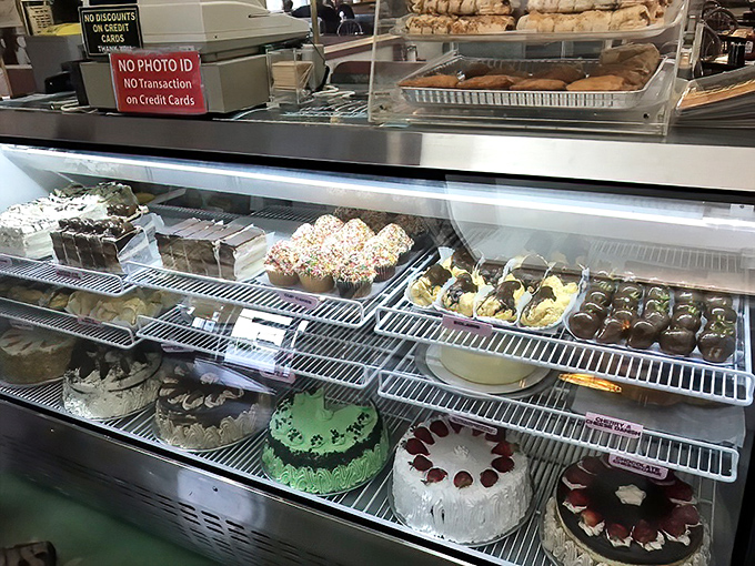 Cakes lined up like sweet soldiers, each one whispering "resistance is futile" to passing diners.