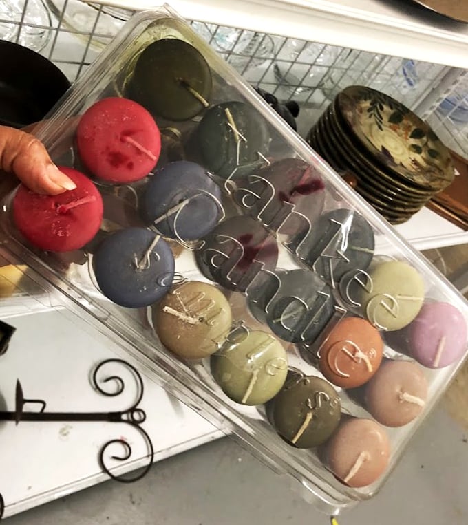 Colorful candles arranged like a dessert tray of scented possibilities. Someone's abandoned aromatherapy collection becomes your next dinner party ambiance.