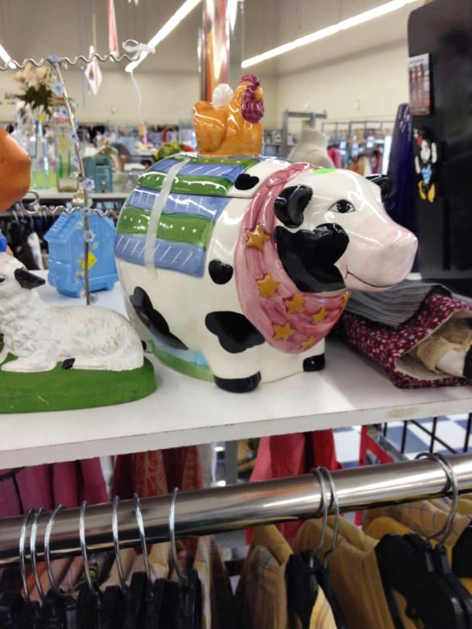 Quirky ceramic finds add character to any home. This cow cookie jar with rooster finial exemplifies the delightful randomness of thrift store discoveries.
