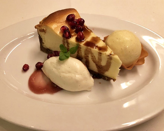 Cheesecake that strikes the perfect balance between dense and fluffy, adorned with pomegranate jewels that pop with tart brightness.