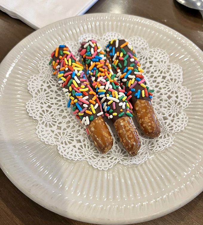 Chocolate-dipped pretzels with rainbow sprinkles &ndash; because sometimes breakfast deserves a little party on a doily.