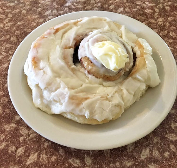 A cinnamon roll that doesn't understand the concept of personal space &ndash; and thank goodness for that. Frosting puddles are a breakfast right.