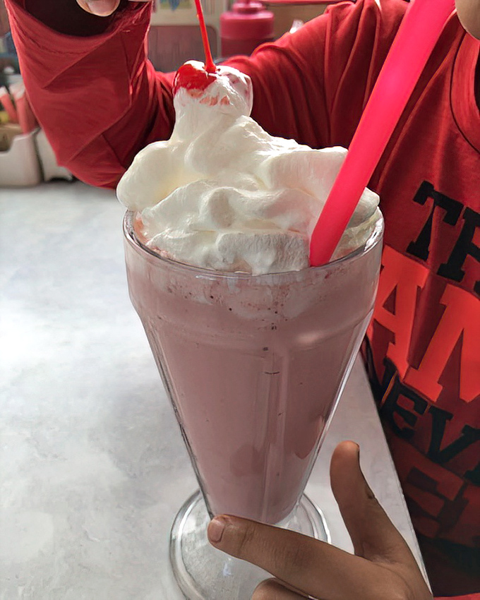 This isn't just a milkshake&mdash;it's a tower of creamy indulgence topped with a cloud of whipped cream. Straws at the ready!