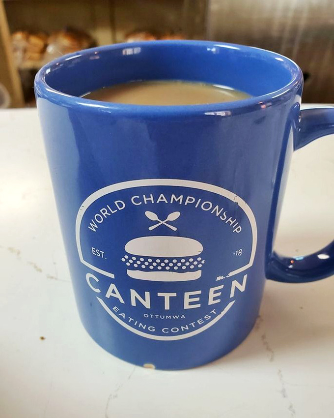 Coffee in a mug celebrating the World Championship Canteen Eating Contest, because apparently competitive eating is a thing here now.