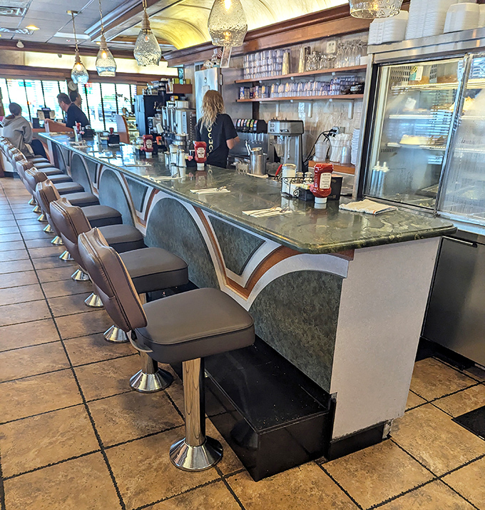 The counter—where solo diners find community, servers find efficiency, and everyone finds that perfect swivel that makes you feel like a kid again.