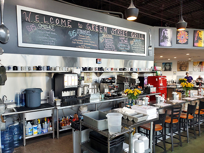 The open kitchen and counter setup lets you watch breakfast magic happen in real time. That chalkboard menu promises treasures worth every calorie.