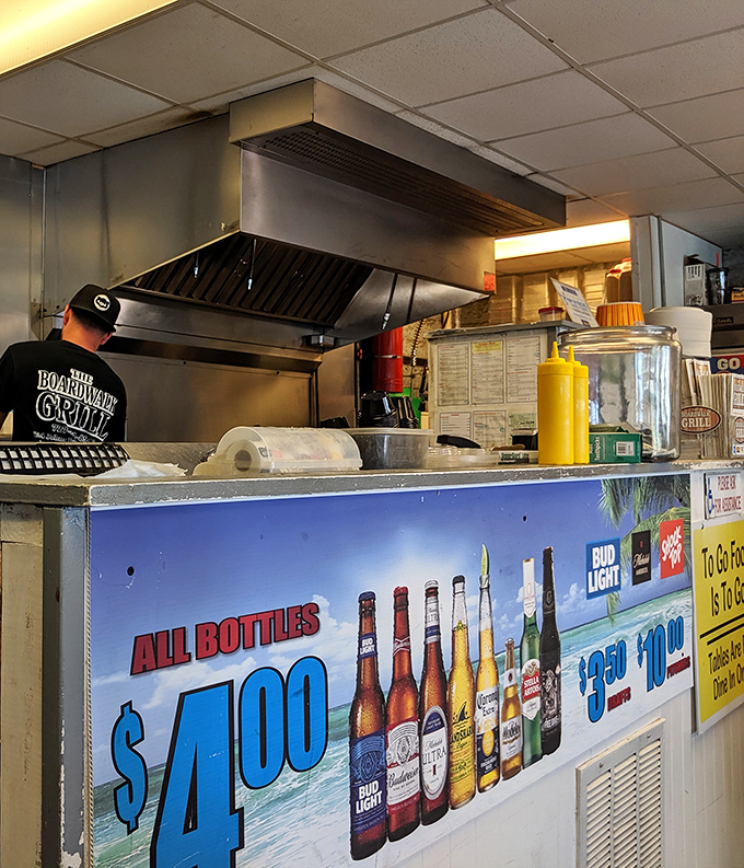 Behind the counter, where magic happens daily. That $4 beer sign isn't just advertising&mdash;it's practically a public service announcement.