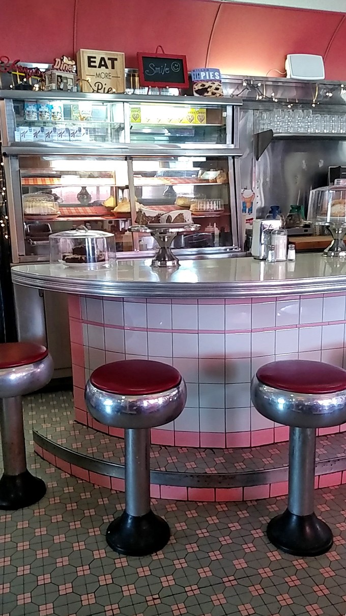 The dessert counter whispers sweet promises with its rotating display of pies. That "EAT MORE PIE" sign isn't just decoration&mdash;it's sound life advice.