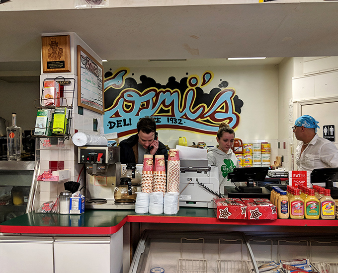 The colorful mural behind the counter reminds you this isn't just any deli &ndash; it's Cosmi's, where sandwich legends are born.