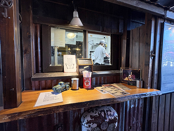 The ordering counter doubles as a museum of Americana, where vintage toys and corrugated metal create the perfect backdrop for culinary anticipation. 