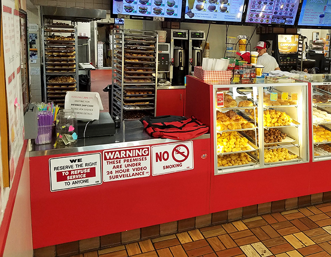 Behind the counter magic where donut dreams become reality and breakfast sandwiches are assembled with surgical precision.