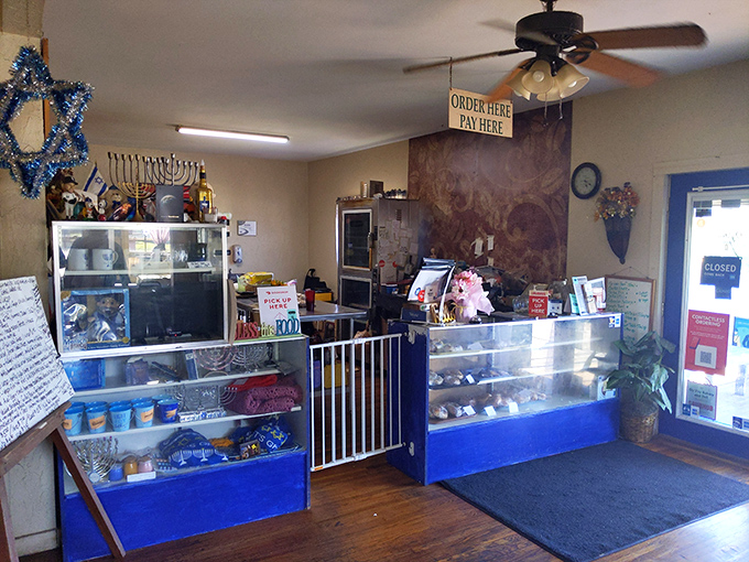 The counter area feels like a portal to another time, with Star of David decorations and display cases promising delicious treasures within.