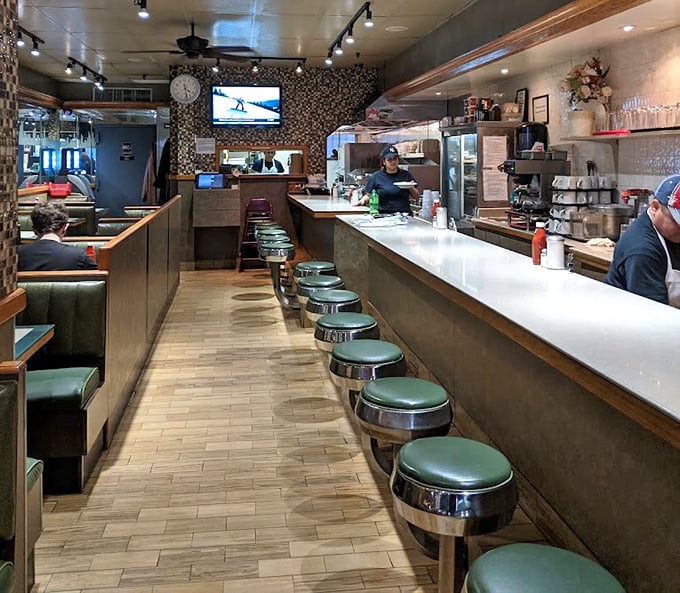The counter seating&mdash;where solo diners become regulars and the short-order ballet unfolds before your eyes. Prime real estate for people-watching.