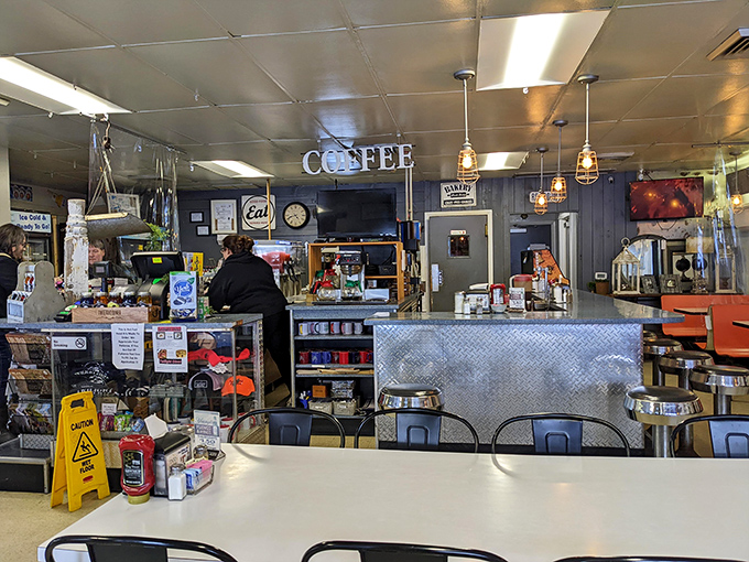 The command center of comfort food operations, where coffee flows freely and the counter seats offer front-row views to culinary magic.