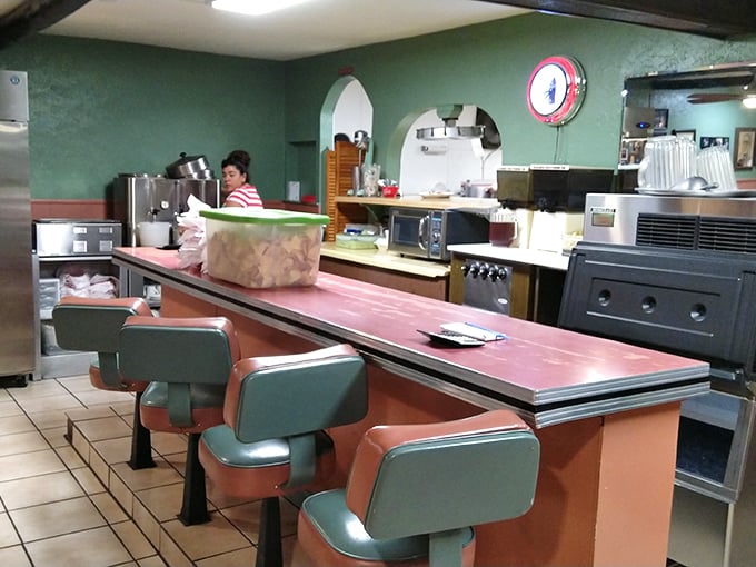 Mint-green walls and retro counter seating create the perfect time capsule where the food hasn't changed because it never needed to.
