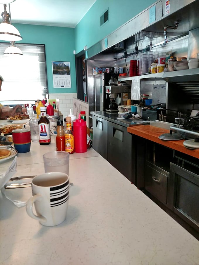 Counter seating offers front-row seats to the breakfast theater, where every order becomes performance art.