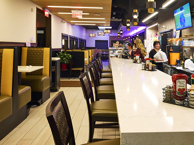 The counter seats – where solo diners become regulars, and regulars become local legends with coffee cups that never empty.