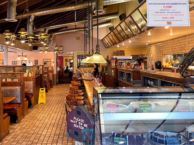 The counter seating area offers front-row views of the kitchen action, where breakfast dreams become delicious reality throughout the day.