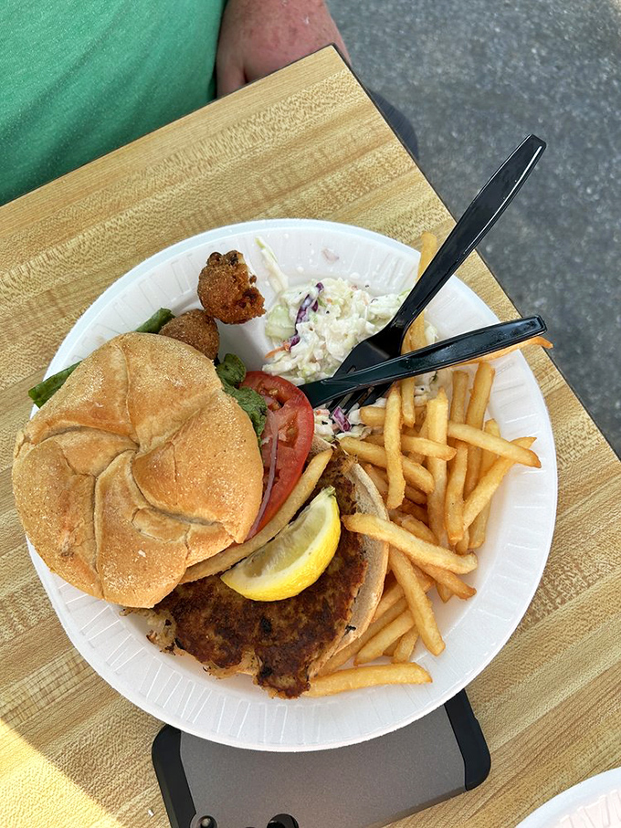 Architecture that matters: a perfectly constructed crab cake sandwich. The foundation is bread, but the soul is pure Lowcountry treasure.