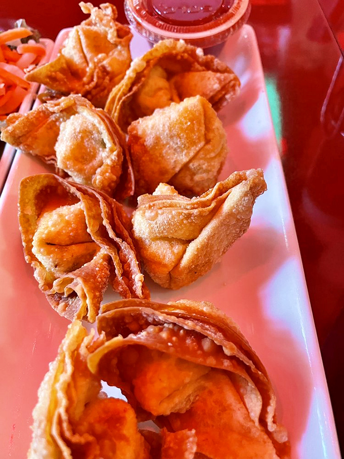 Golden-fried wontons that shatter with a satisfying crunch, revealing a creamy interior that makes you forget about dessert menus entirely.