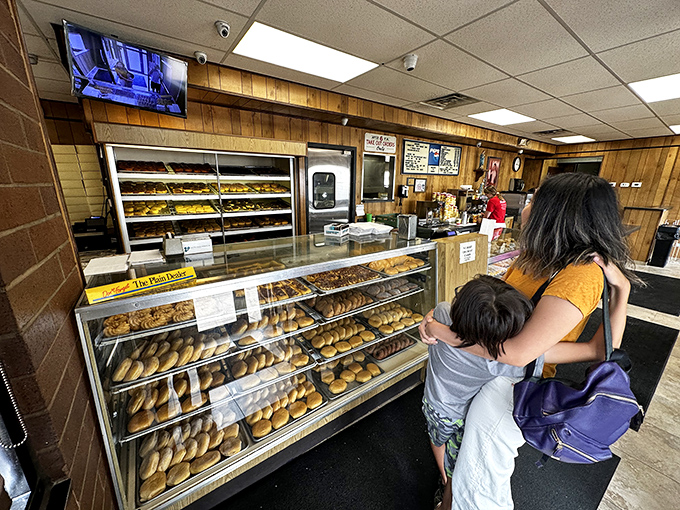 The true measure of a great donut shop: locals willing to wait in line with their children, passing down the tradition to the next generation.
