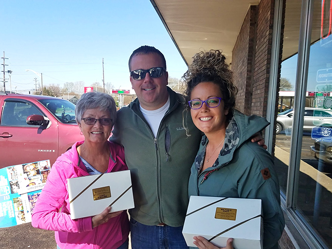 Happy customers clutching their white boxes like treasure chests, knowing the contents might not survive the car ride home.