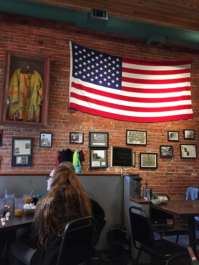 Old firefighting gear and patriotic pride displayed on century-old brick &ndash; history preserved while serving up contemporary comfort food excellence.