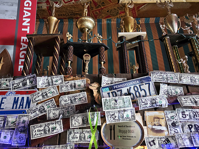 Dollar bills and memorabilia line the walls like a scrapbook of good times. Each one represents a story, probably involving someone saying "I'm stuffed."