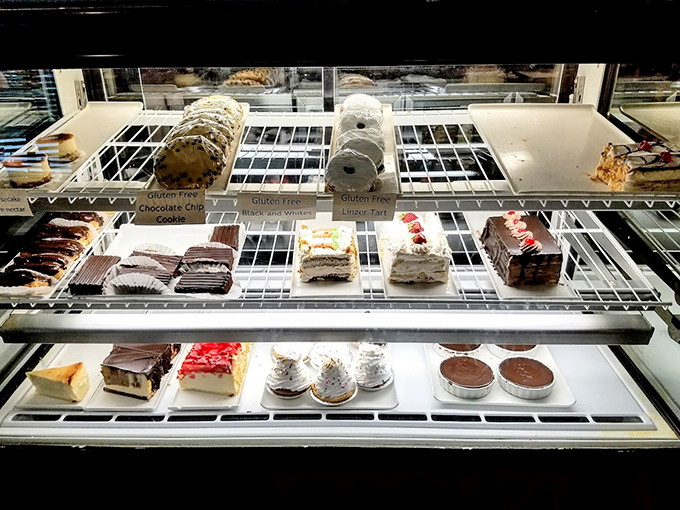 The dessert case—a glass-enclosed museum of temptation where willpower goes to die and "I'll just have a bite" becomes a beautiful lie.
