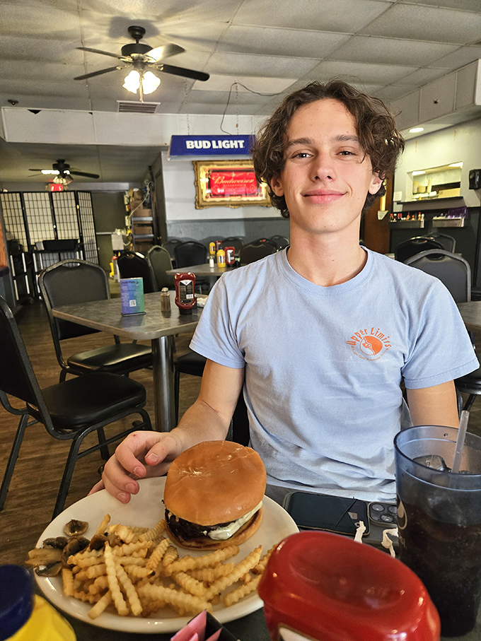 The dining room where strangers become regulars and regulars become family. That burger looks like it's about to make someone's day significantly better.