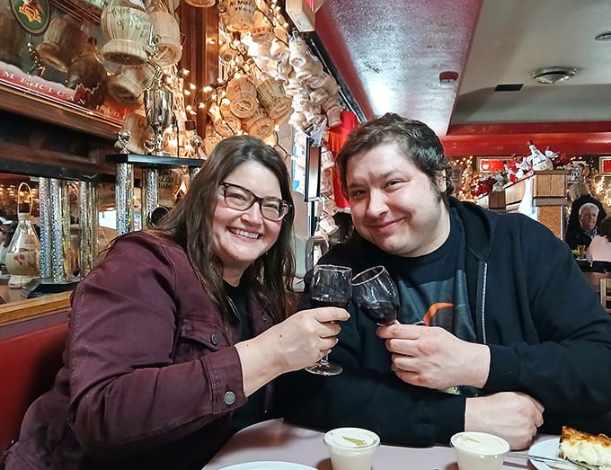 Happy diners toasting to the universal truth: great pizza creates great moments. Their expressions say what words can't&mdash;they've found pizza nirvana.