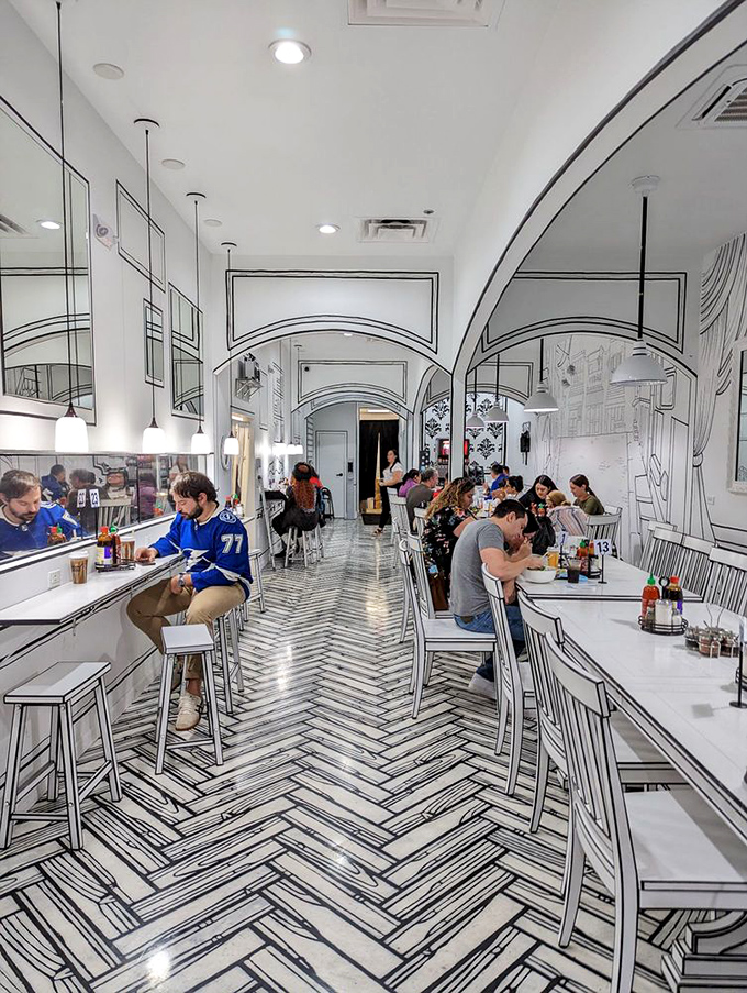 The restaurant buzzes with diners experiencing food and fantasy simultaneously. Notice how everyone's phones are out&mdash;this place is social media catnip.