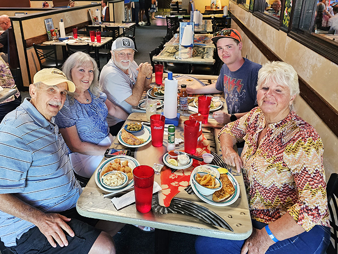 Multi-generational families gather around tables laden with seafood, creating memories that taste like butter and Old Bay.