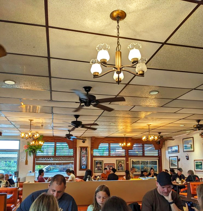 Where locals and visitors unite under the universal religion of "breakfast food at any hour." The ceiling fans keep the good vibes circulating.