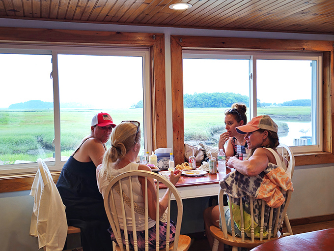 Happiness looks like this: friends sharing seafood with a backdrop of Essex marshland. Some conversations just taste better with fried clams.