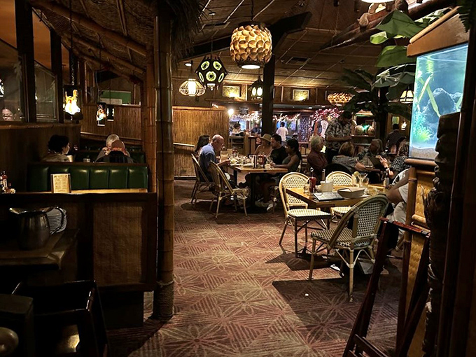 Diners bask in the warm glow of tiki lamps, creating the perfect atmosphere for that "I can't believe we haven't been here before" conversation.