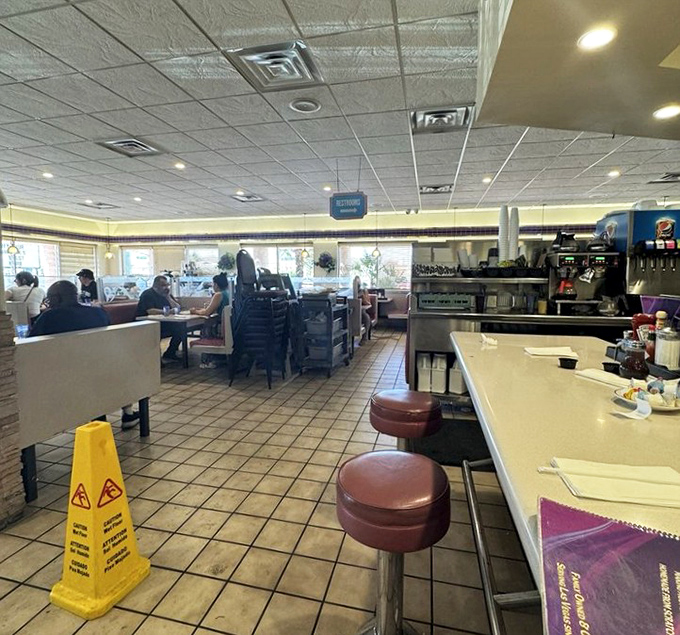 A dining room where strangers become temporary family, united by the universal language of "pass the syrup, please."