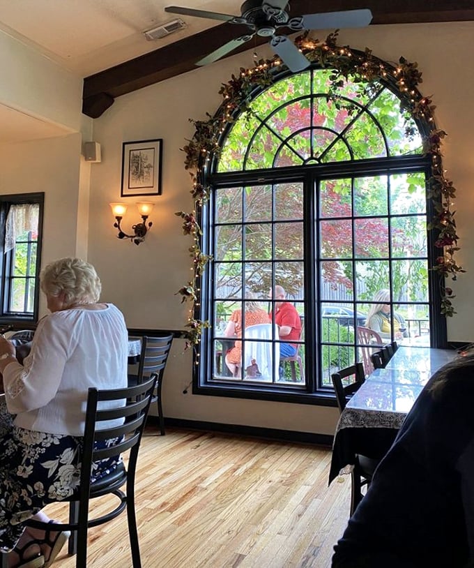 The arched windows framed with twinkling vines create the perfect backdrop for diners enjoying what looks like the Italian version of "happily ever after."