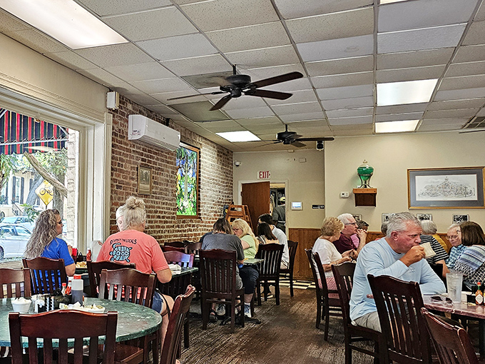 Morning light streams through windows onto happy diners experiencing what might be the most civilized form of time travel: breakfast in historic Savannah.
