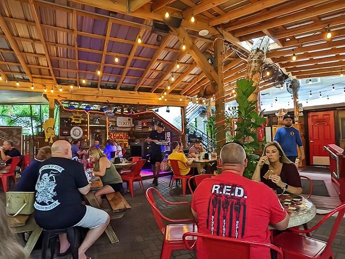 Diners gather under wooden beams and string lights, creating that perfect Florida evening vibe where time slows and appetites grow.