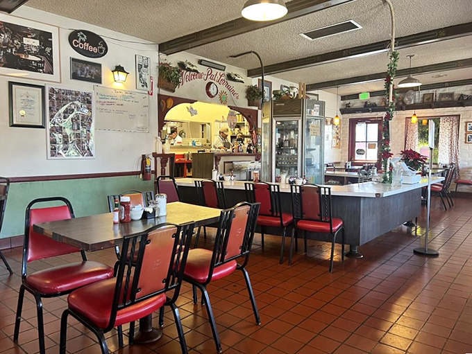 Red chairs against terra cotta floors create the classic diner aesthetic where both screenwriters and construction workers feel equally at home.