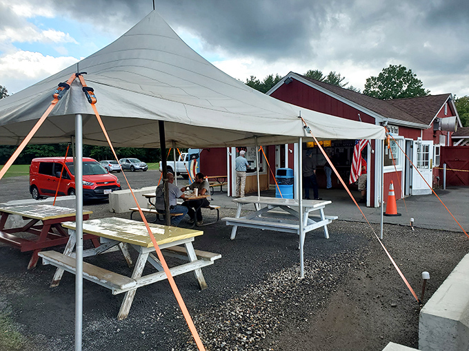 Outdoor seating under the tent where you can watch Route 5 roll by while sauce drips gloriously down your chin.